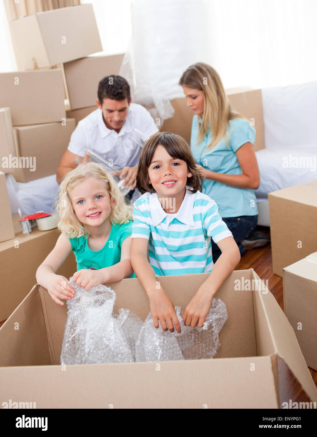Lively family packing boxes Stock Photo - Alamy