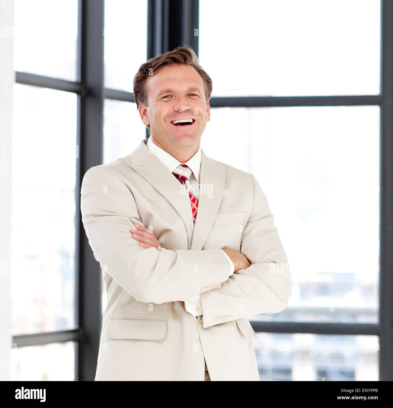 Business leader with folded arms smiling at the camera Stock Photo - Alamy
