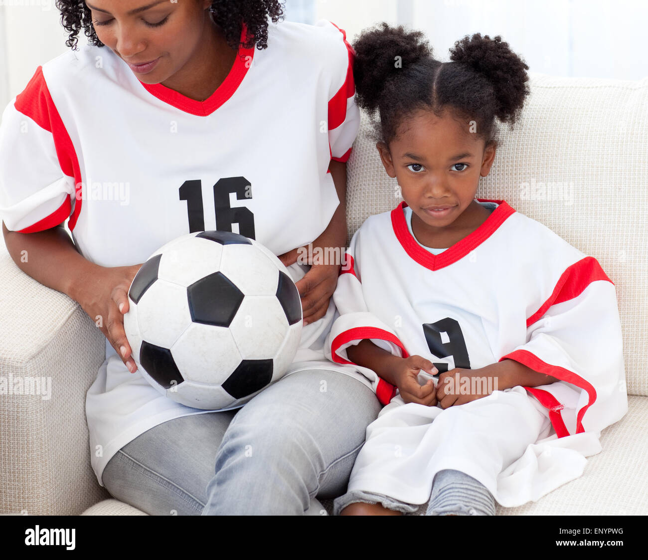 Mother and her daughter watching a football match Stock Photo - Alamy