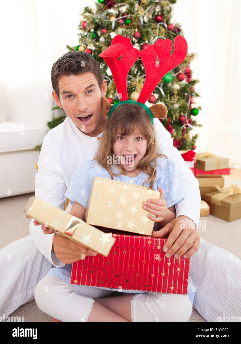 Surprised father and his girl opening Christmas gifts Stock Photo - Alamy