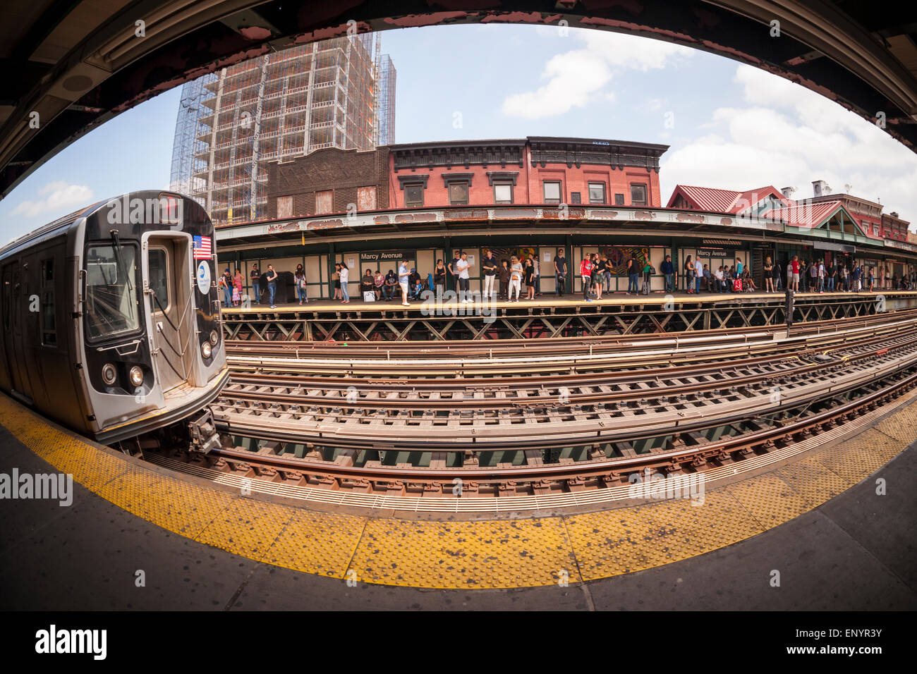 Passengers crowd the subway platform of the Marcy Avenue station, the "J" and "M" lines, in ...