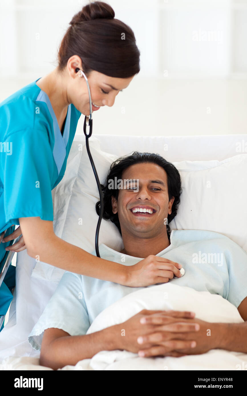A doctor checking the pulse of a smiling patient Stock Photo - Alamy