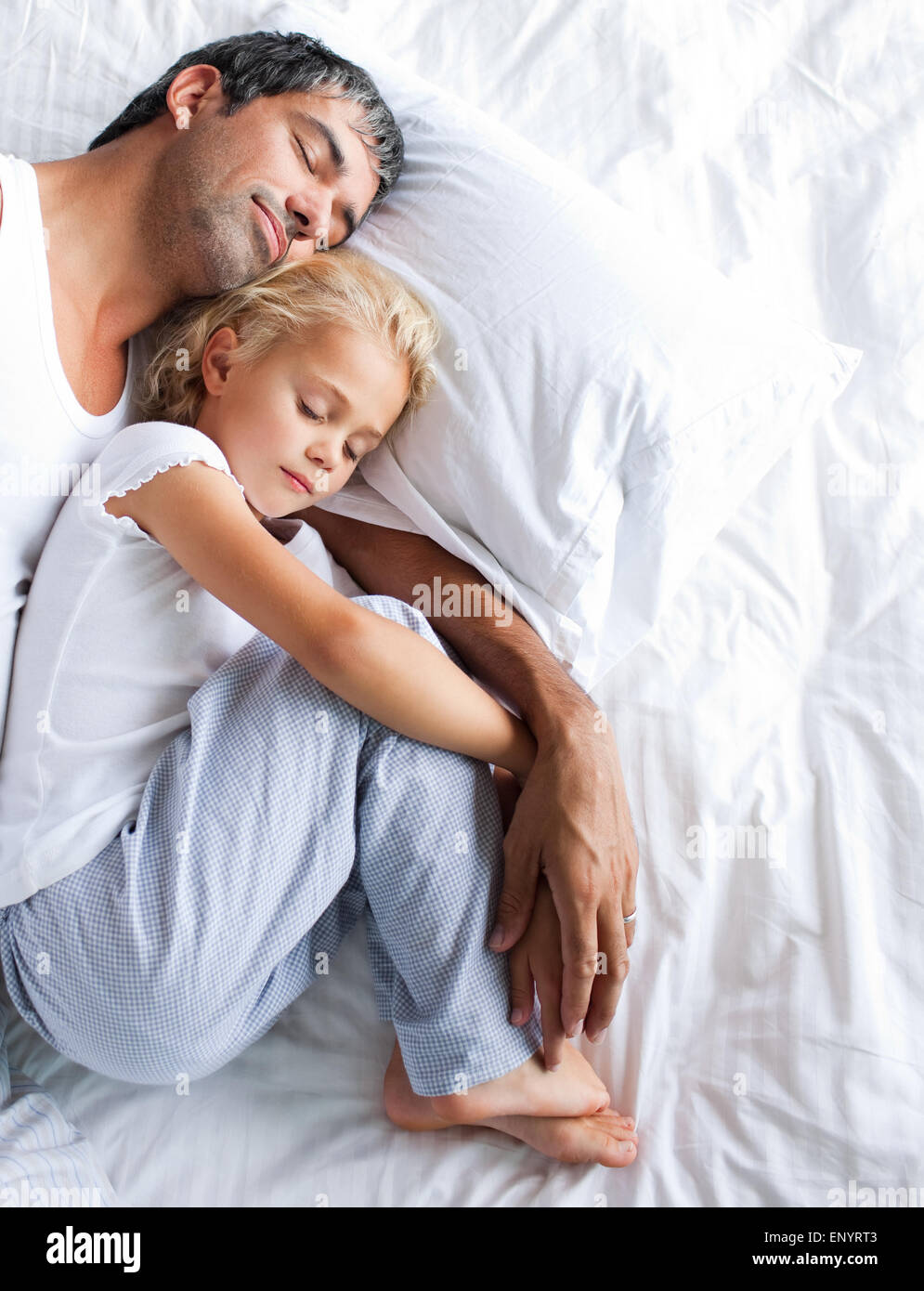 Father and daughter sleeping on bed Stock Photo - Alamy