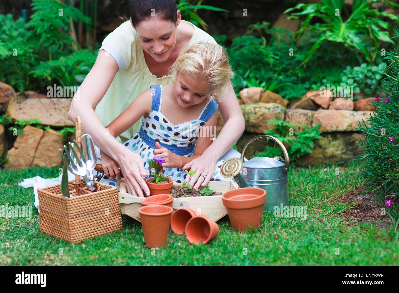 Young mother and daughter planting flowers Stock Photo - Alamy