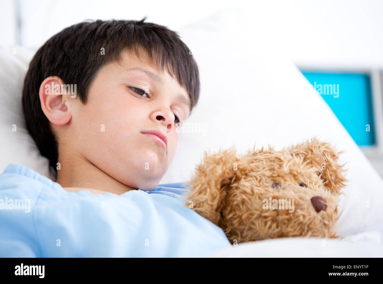 Portrait of a sick boy lying in a hospital bed Stock Photo - Alamy