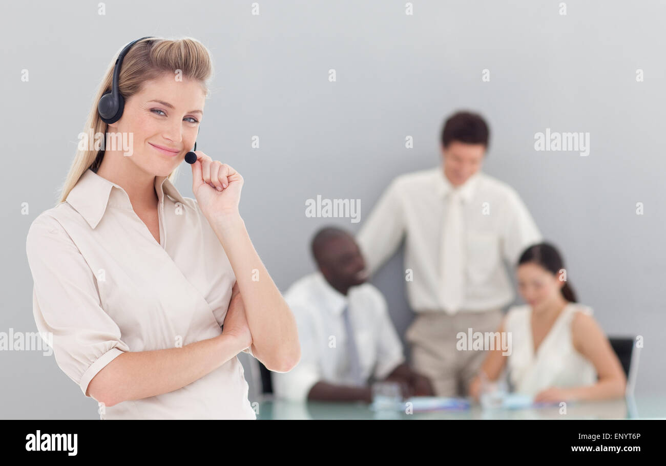Confident female sales respresentative with her team Stock Photo - Alamy