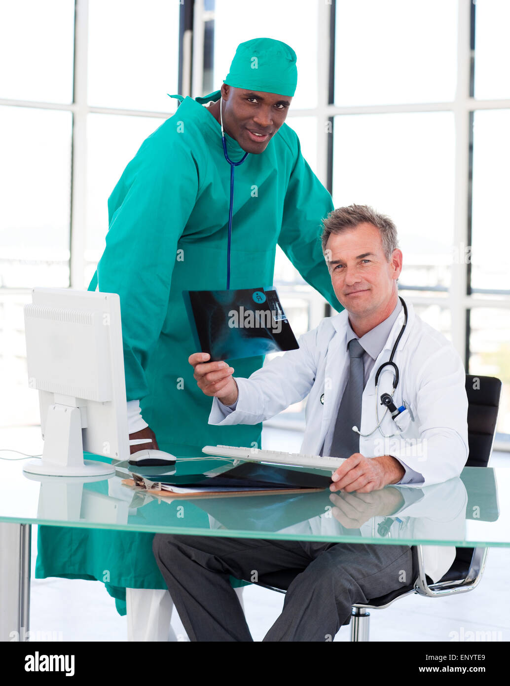 Doctors looking at the camera with an X-ray Stock Photo - Alamy