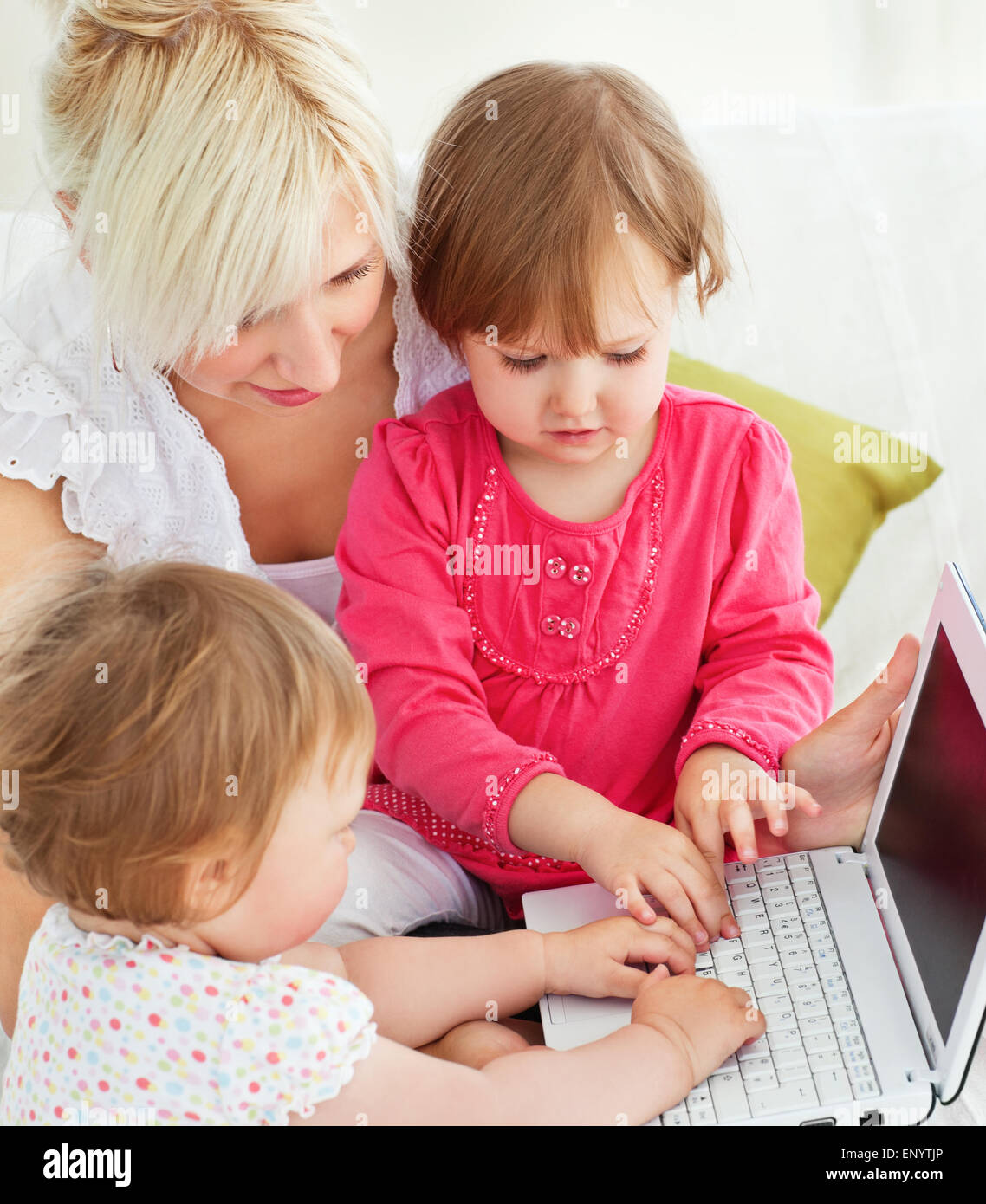 Cheerful family having fun with a laptop in the living-room Stock Photo ...