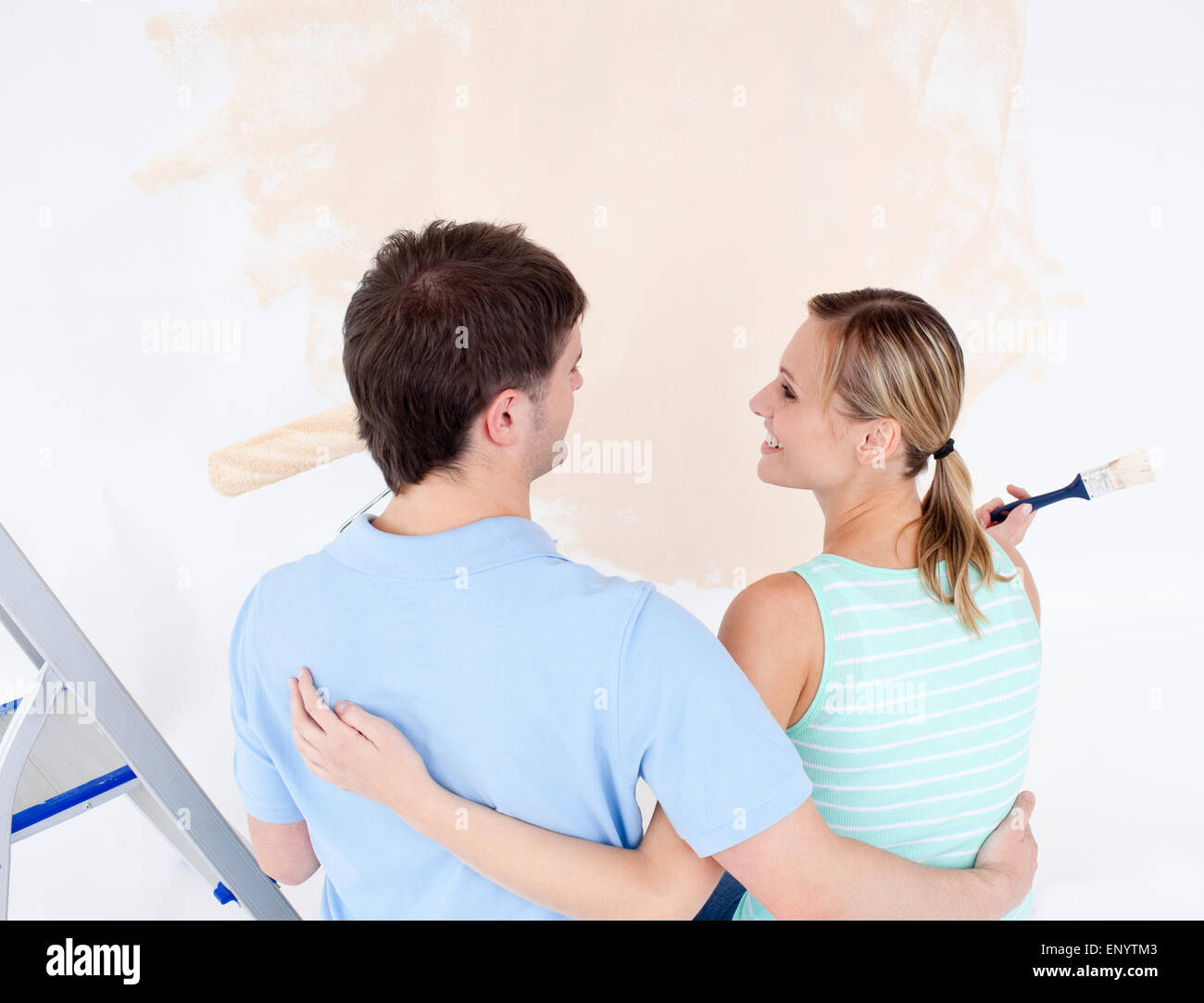Affectionate couple painting a room Stock Photo - Alamy