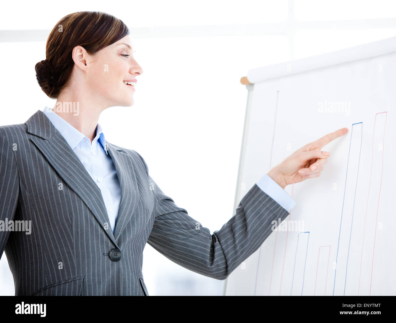 Portrait of a laughing businesswoman talking about a graph during a ...