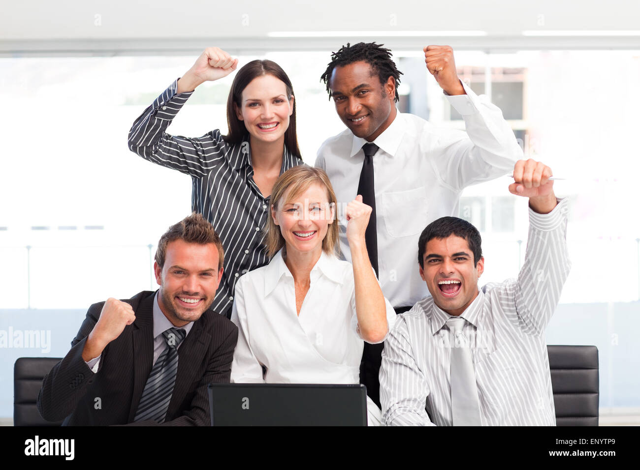 Happy business team celebrating a success in office Stock Photo - Alamy