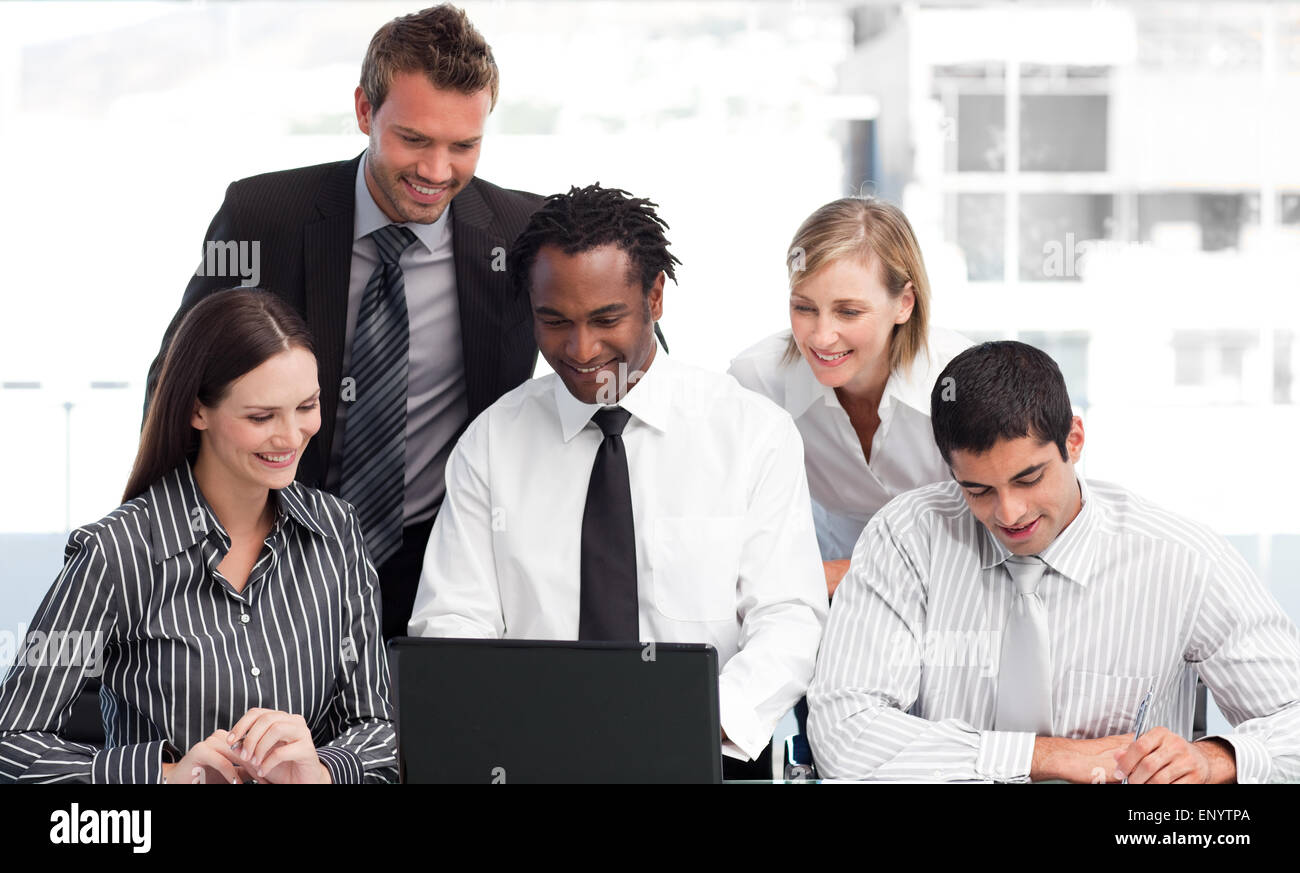 Multi-ethnic business team working with a laptop Stock Photo - Alamy