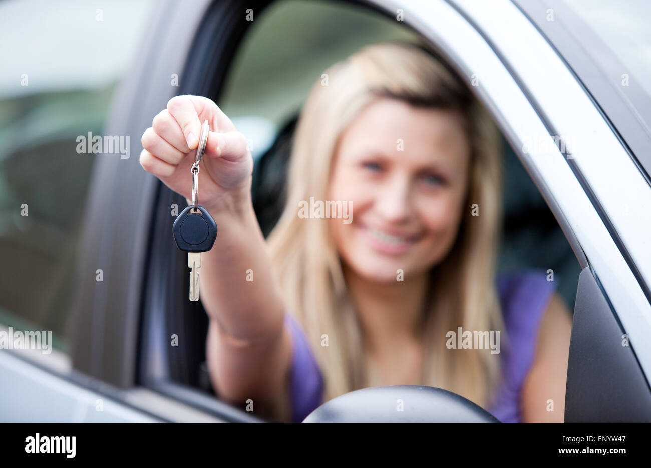 Young female driver holding a key Stock Photo - Alamy