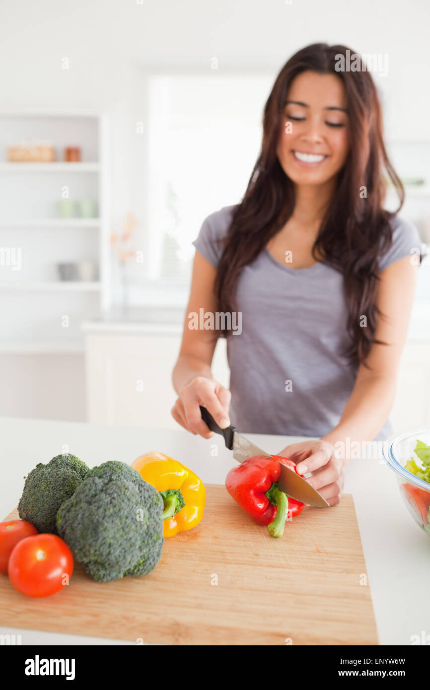 Charming female cooking vegetables while standing Stock Photo - Alamy