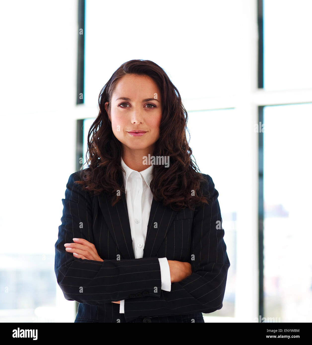 Confident businesswoman with folded arms Stock Photo - Alamy