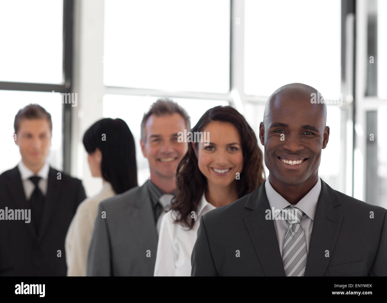 Five person Business team looking at camera and smiling Stock Photo - Alamy