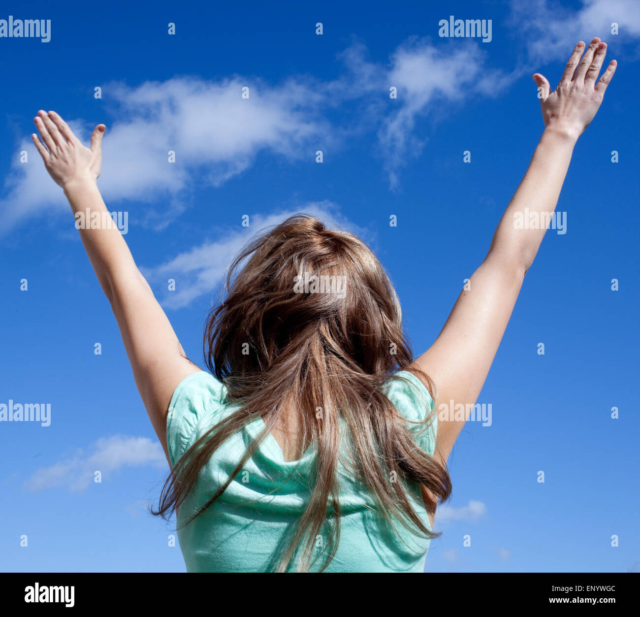 Relaxed woman punching the air outdoor Stock Photo - Alamy