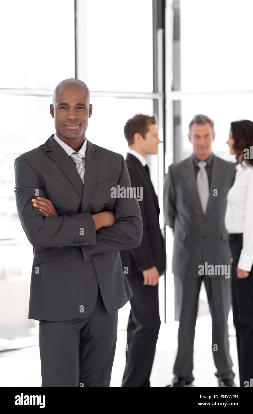 Young Businessman standing out from the Crowd Stock Photo - Alamy