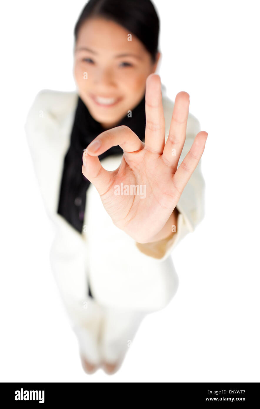 Confident businesswoman showing OK sign against a white background Stock Photo - Alamy