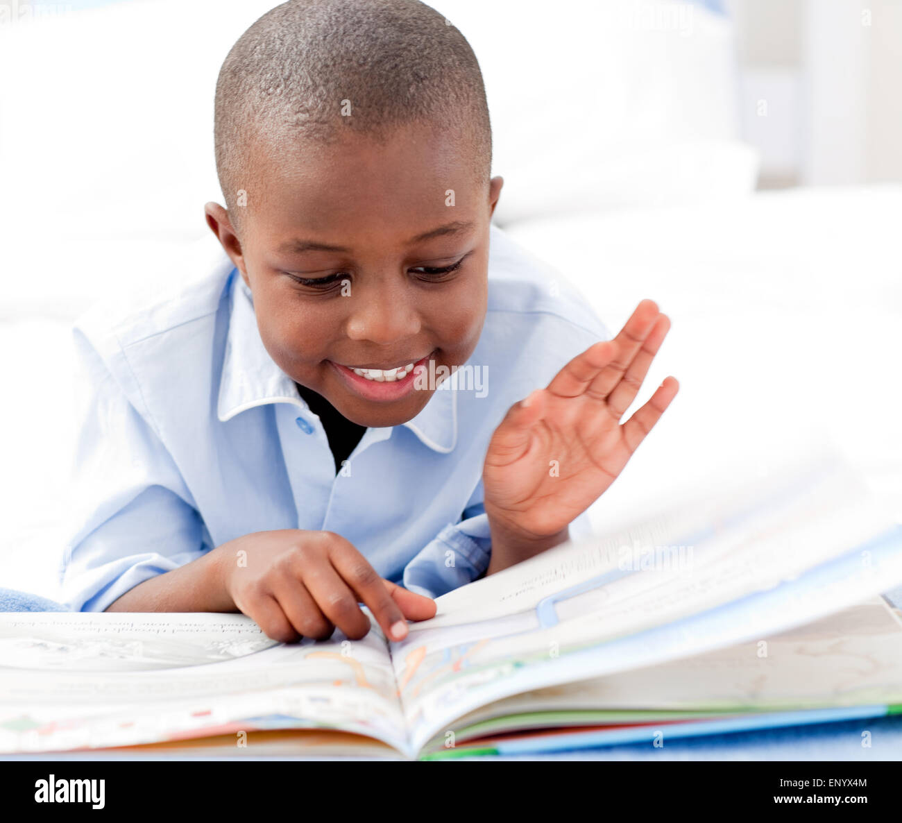 Small boy reading a book Stock Photo - Alamy
