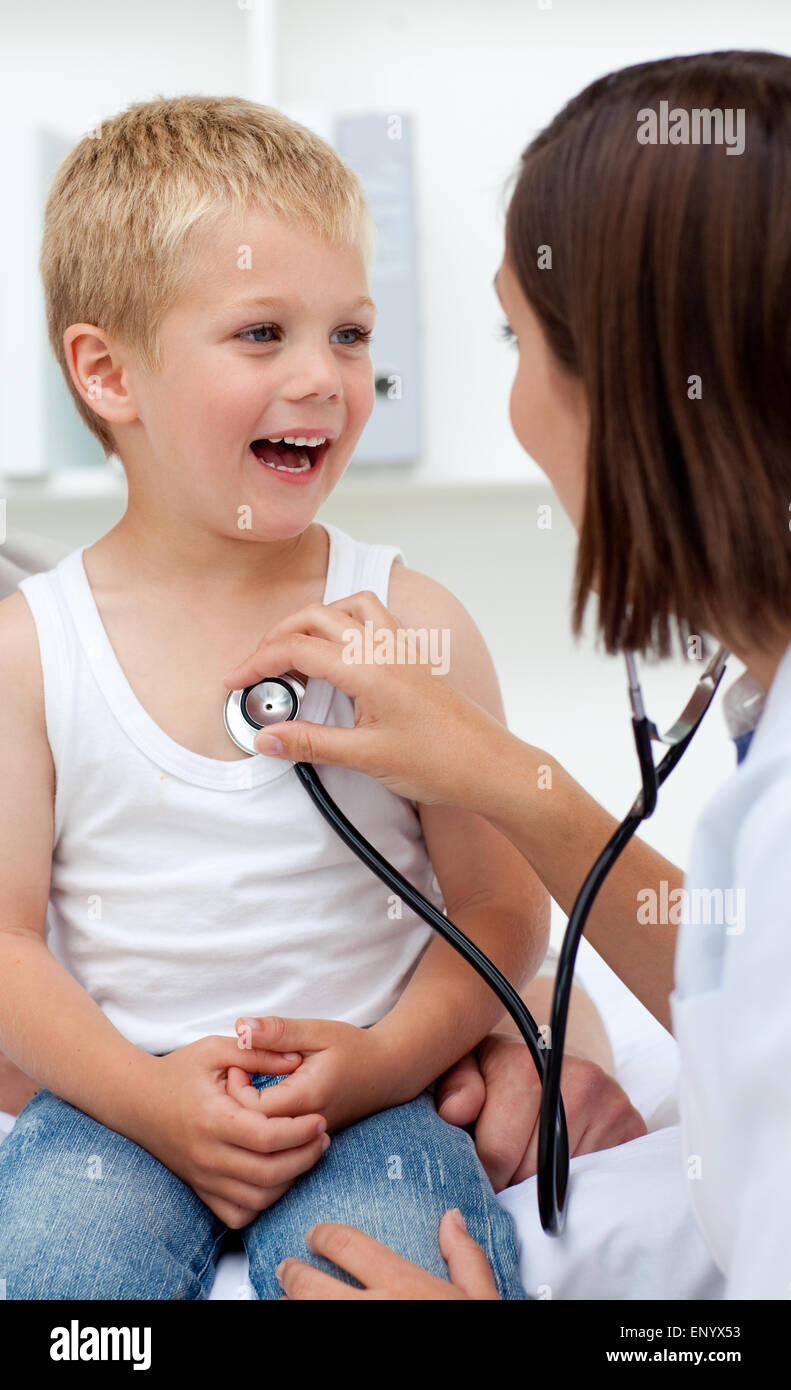 A doctor checking the pulse on a smiling little boy Stock Photo - Alamy