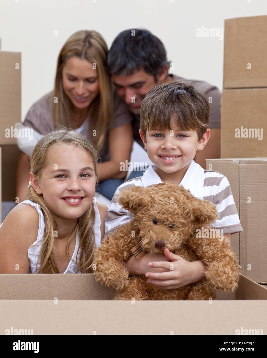 Little boy and girl moving house with parents Stock Photo - Alamy
