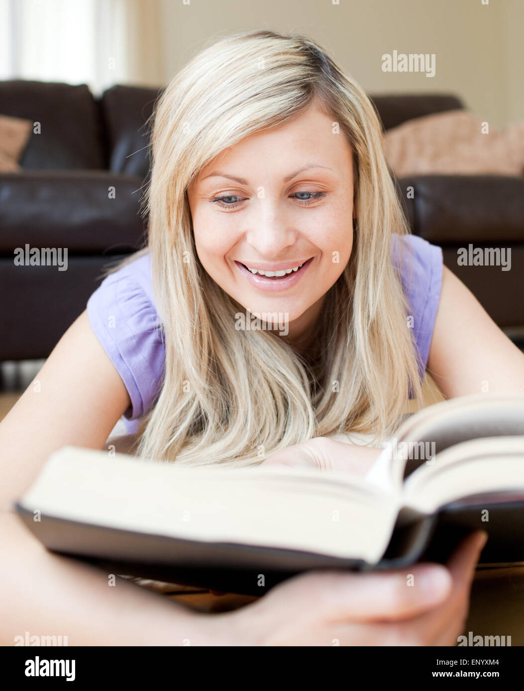Happy woman reading a book Stock Photo - Alamy