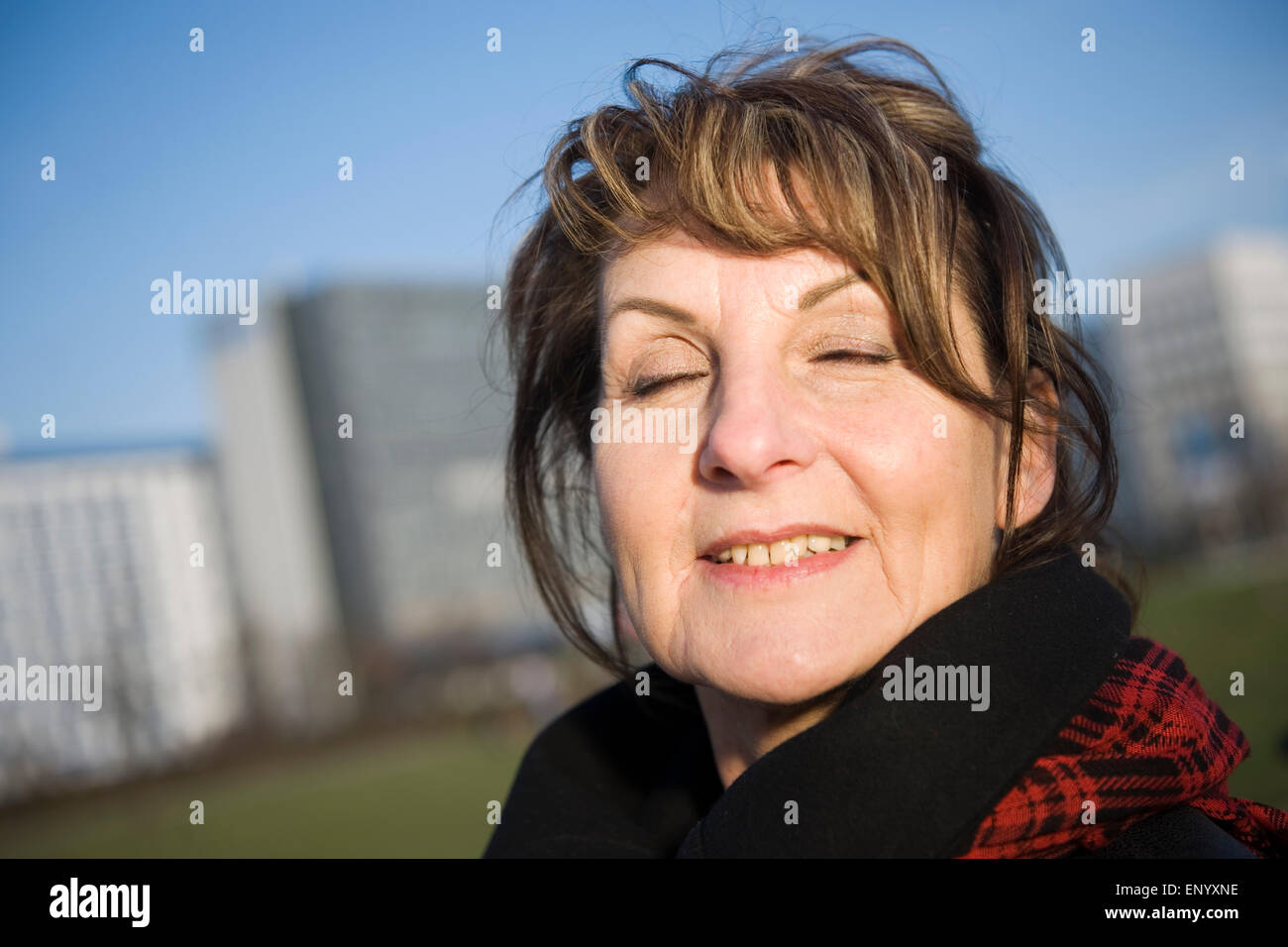 lateral head portrait of a mature woman in Fuzzy urban light deep ...