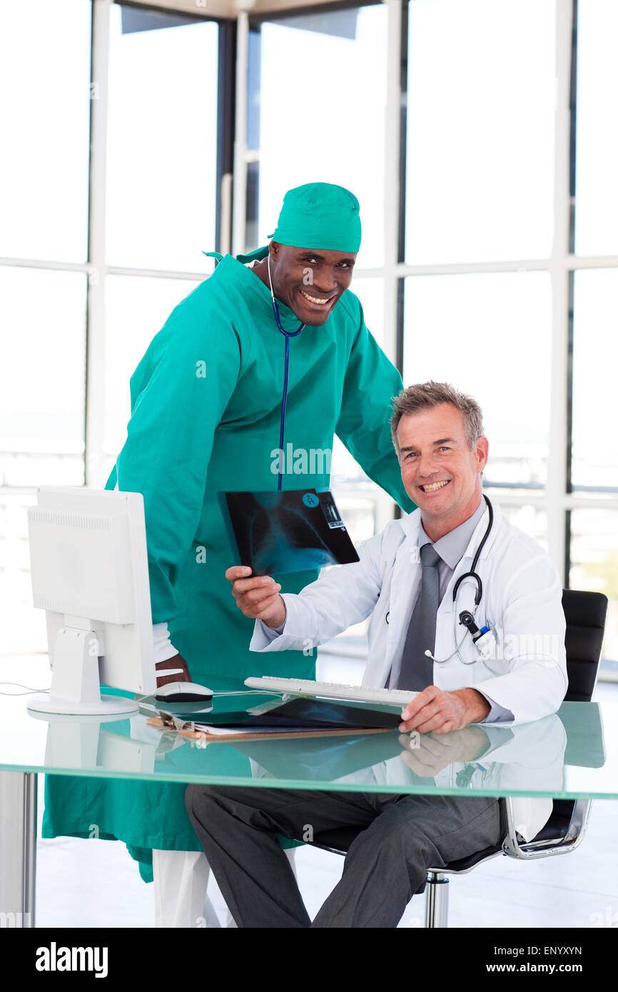 Two doctors talking about two x-rays Stock Photo - Alamy