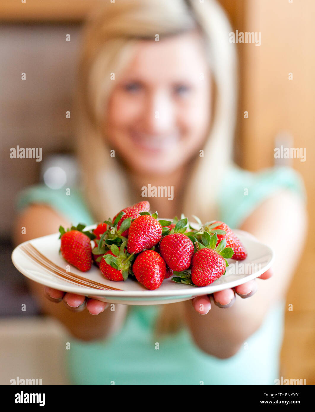 Positive woman showing fruits Stock Photo - Alamy