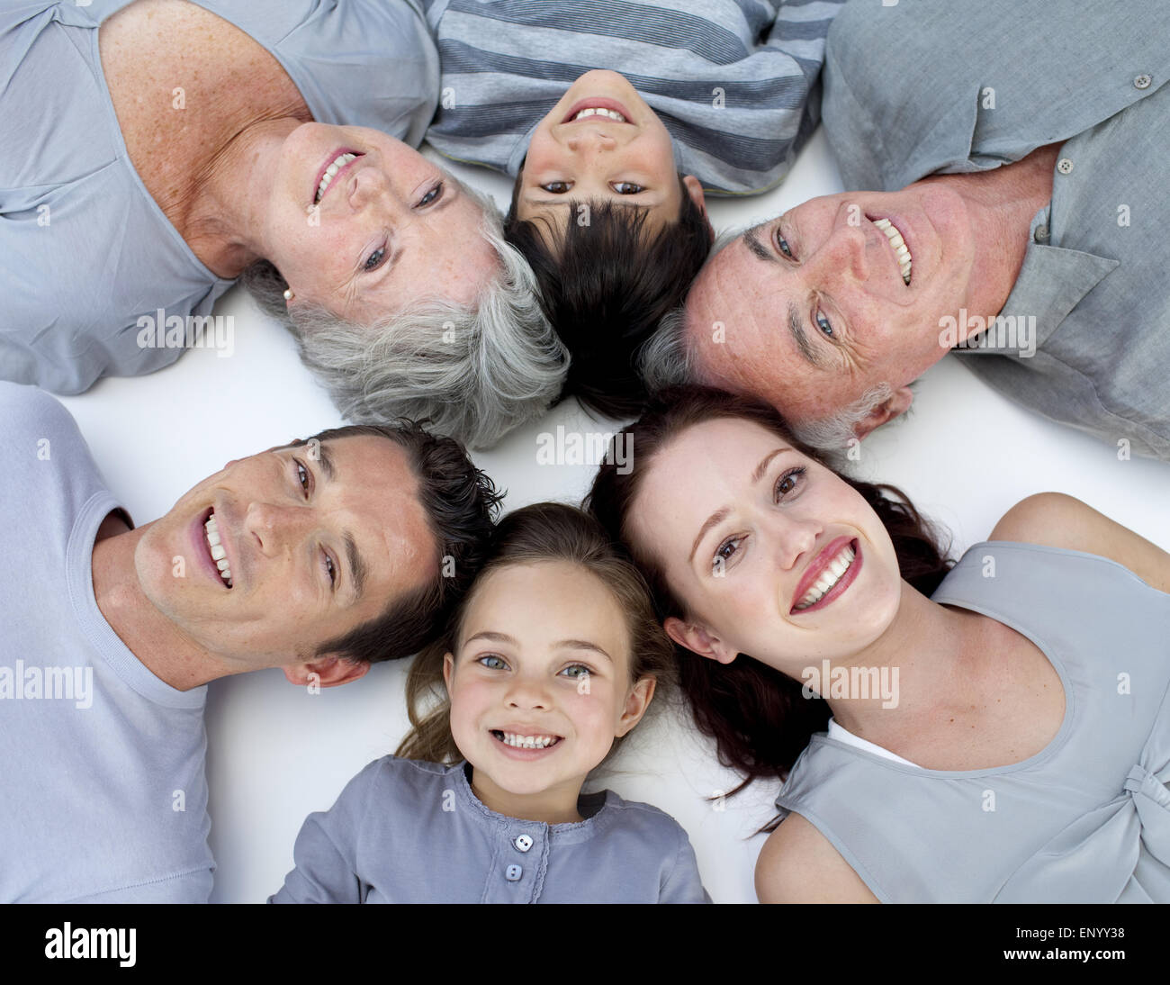 High angle of family lying on floor with heads together Stock Photo - Alamy