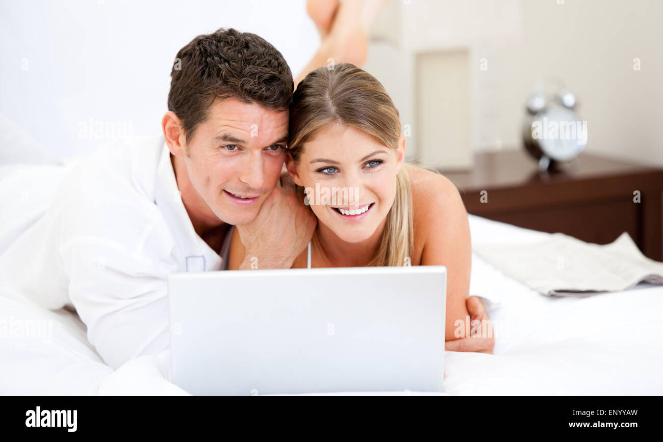 Positive couple surfing on the internet Stock Photo - Alamy