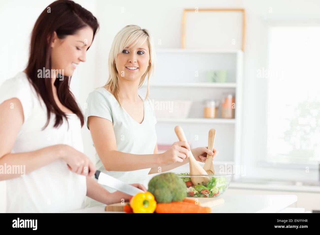Cheerful Women preparing dinner Stock Photo - Alamy