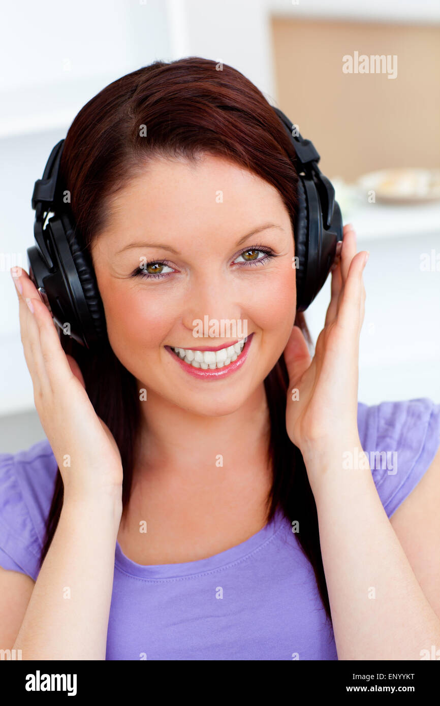 Smiling pretty woman listen to music with headphones looking at the ...