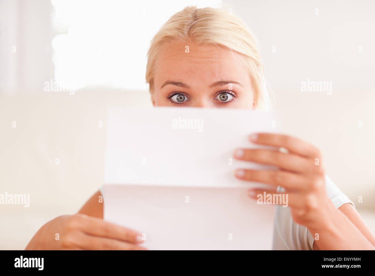 Shocked woman reading a letter Stock Photo - Alamy