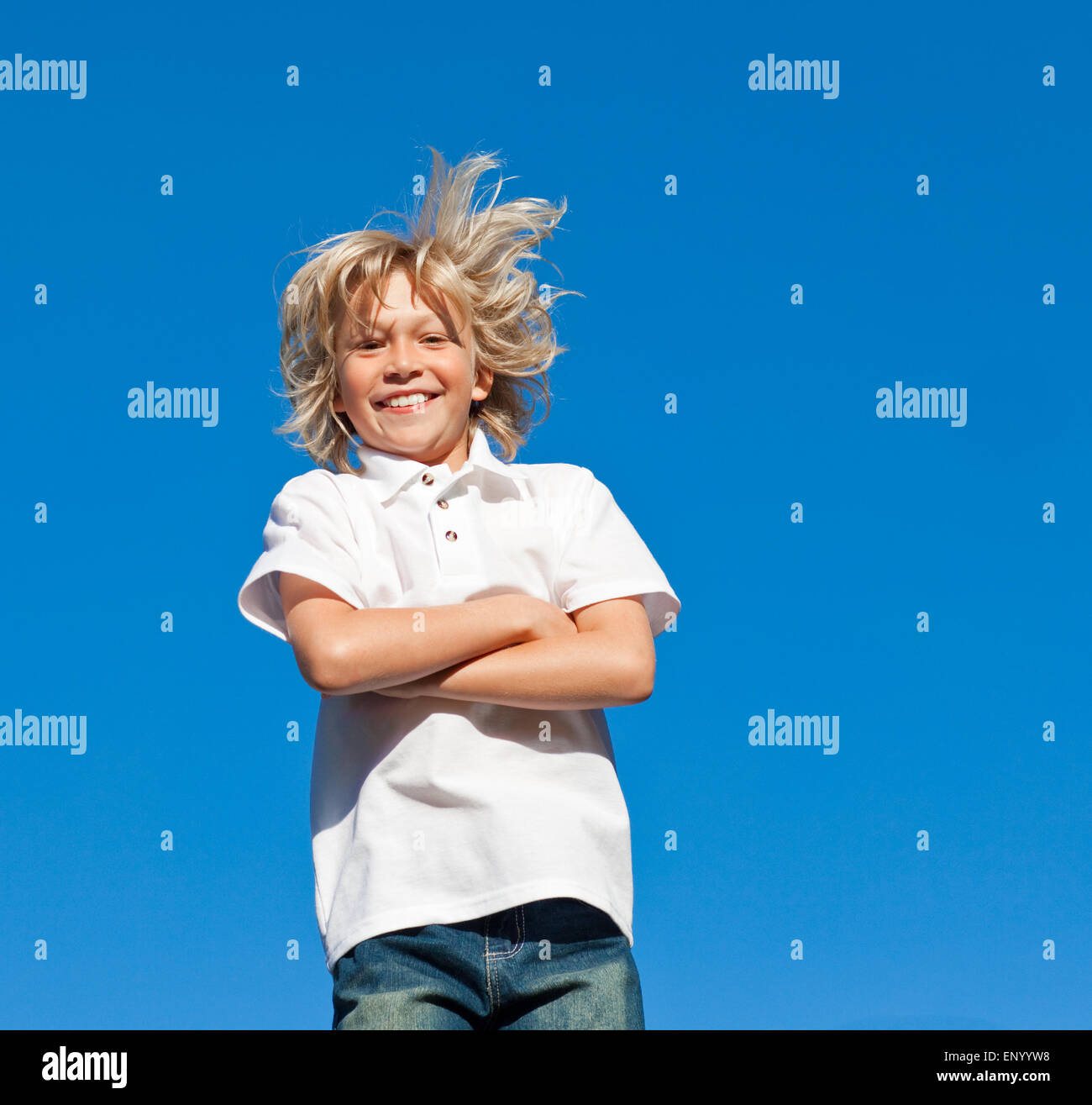 Cute Kid with arms folded having fun outdoor Stock Photo - Alamy