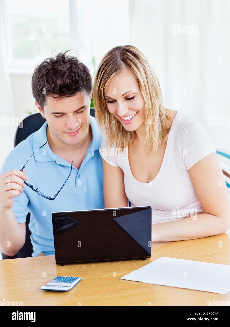 Young couple watching the screen of the laptop Stock Photo - Alamy