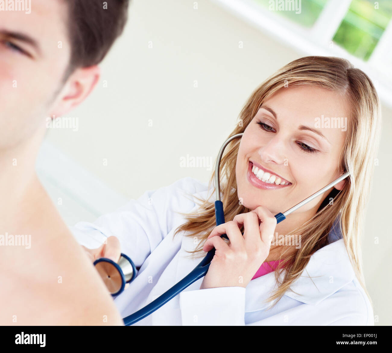 Smiling doctor is examinating her patient Stock Photo - Alamy