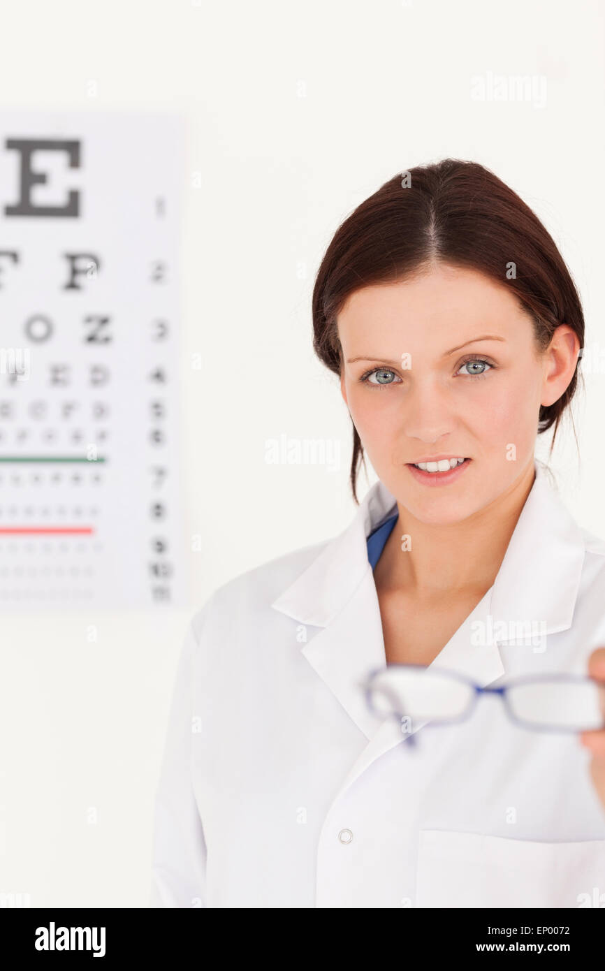 Female optician showing glasses Stock Photo - Alamy