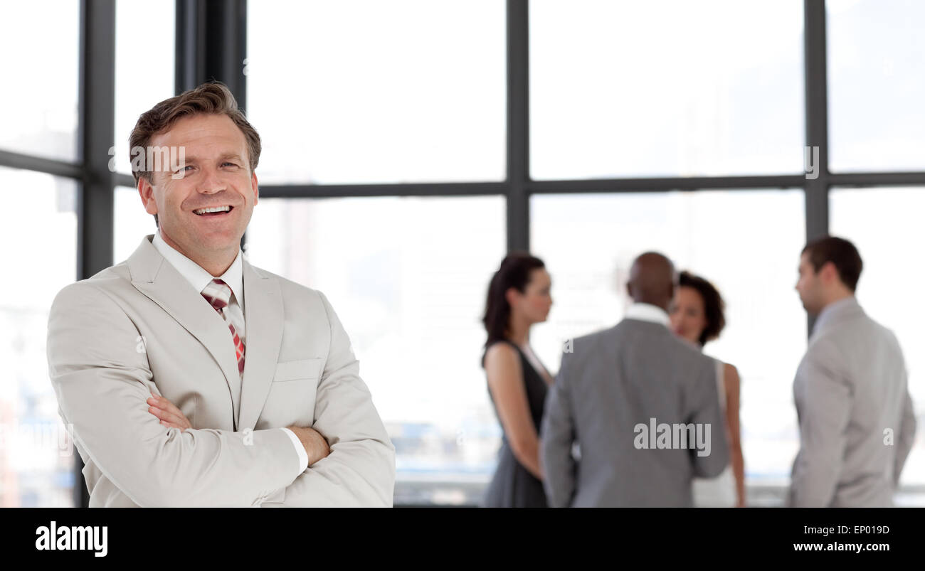 Joyful male manager leading his team Stock Photo - Alamy