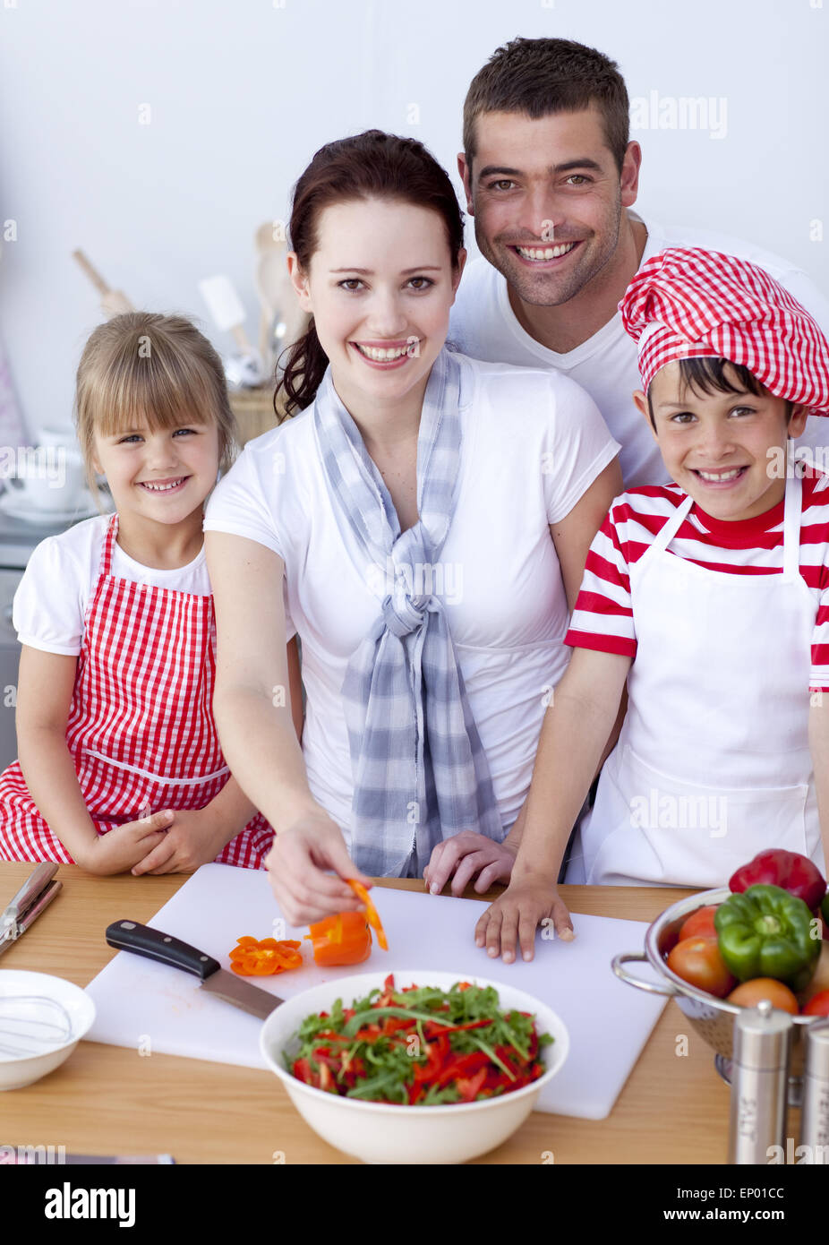 Family cutting colourful peppers in kitchen Stock Photo - Alamy