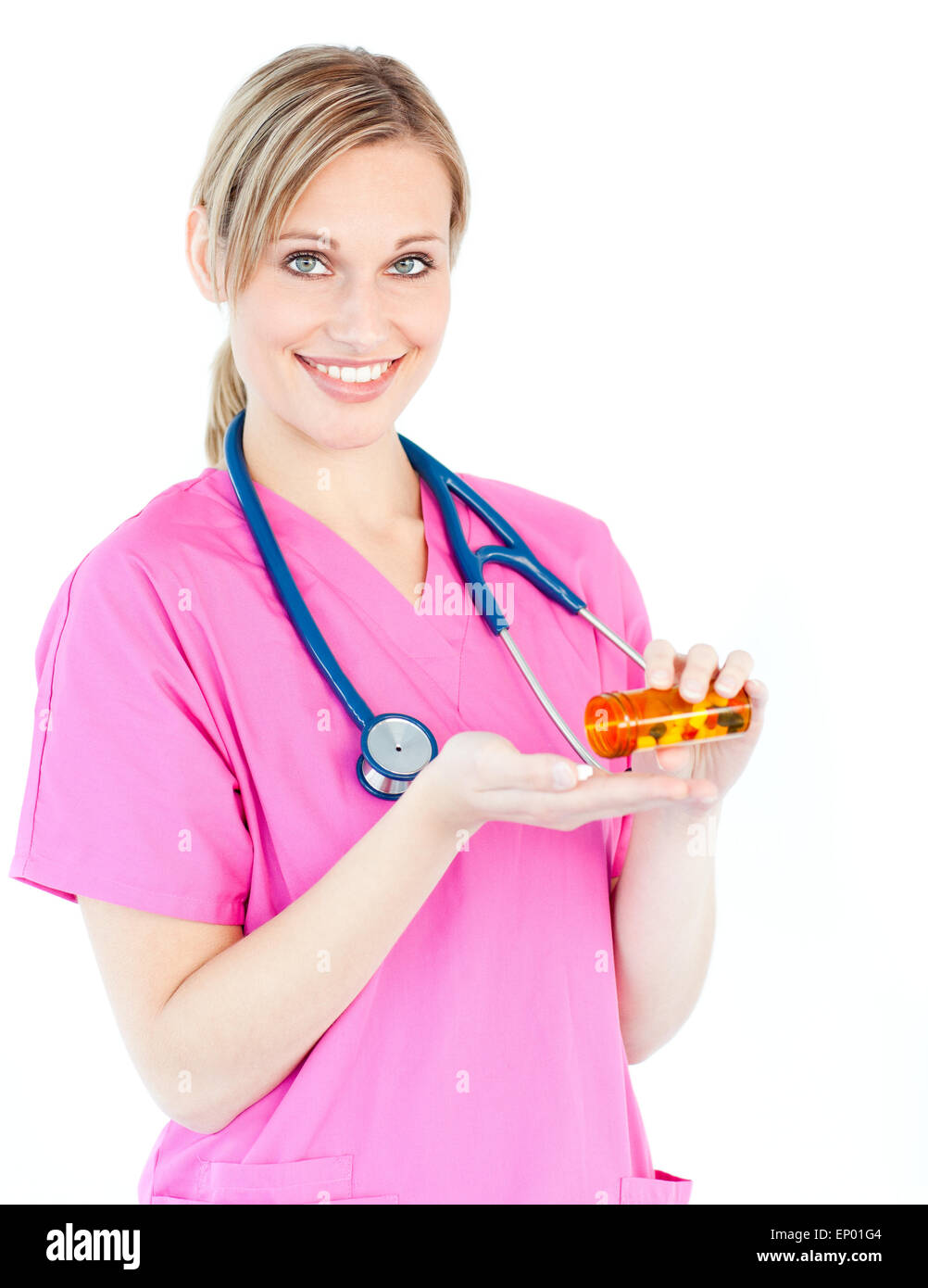 Confident female nurse holding pills smiling at the camera against ...