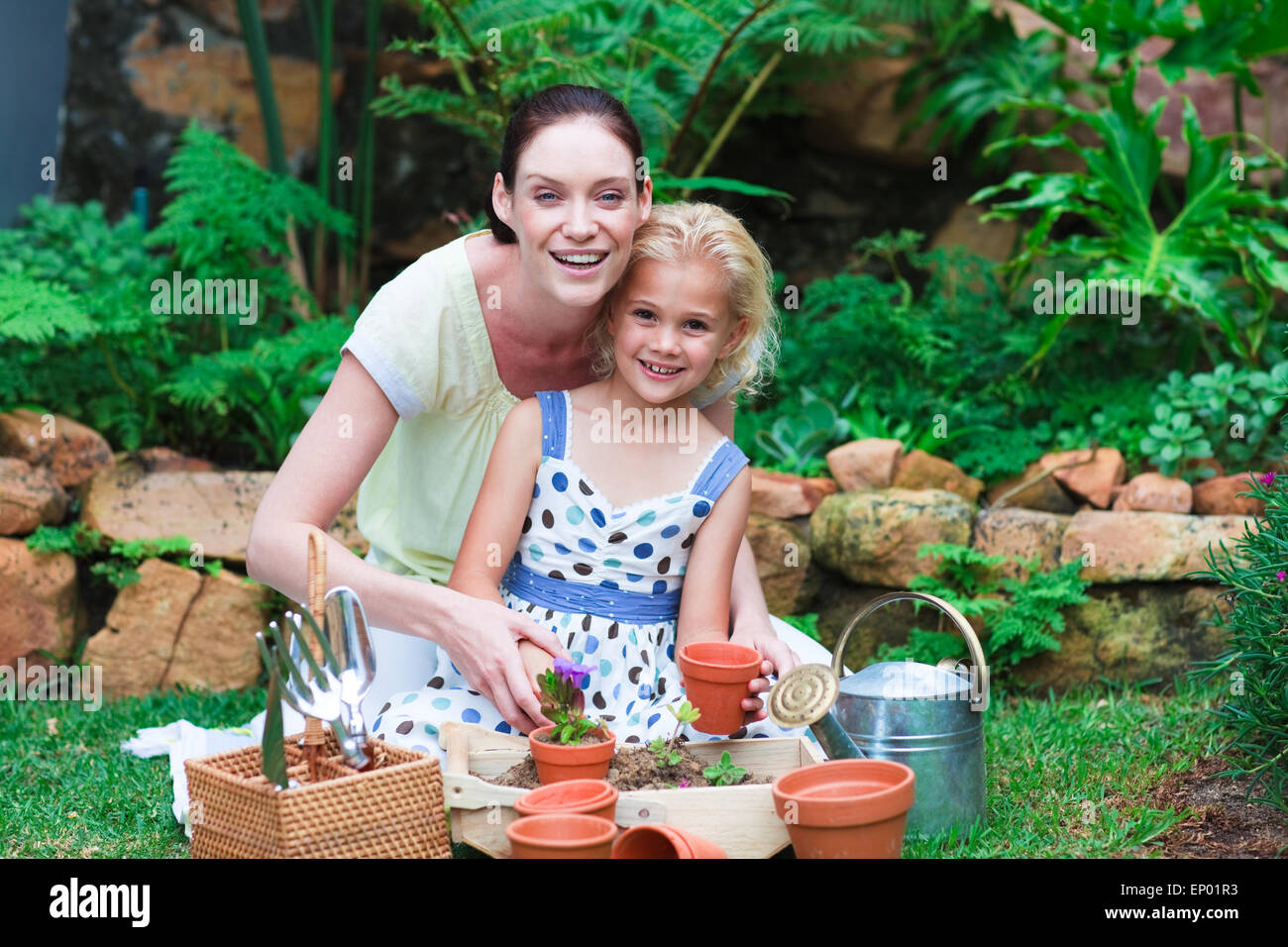 Young mother and daughter planting flowers Stock Photo - Alamy