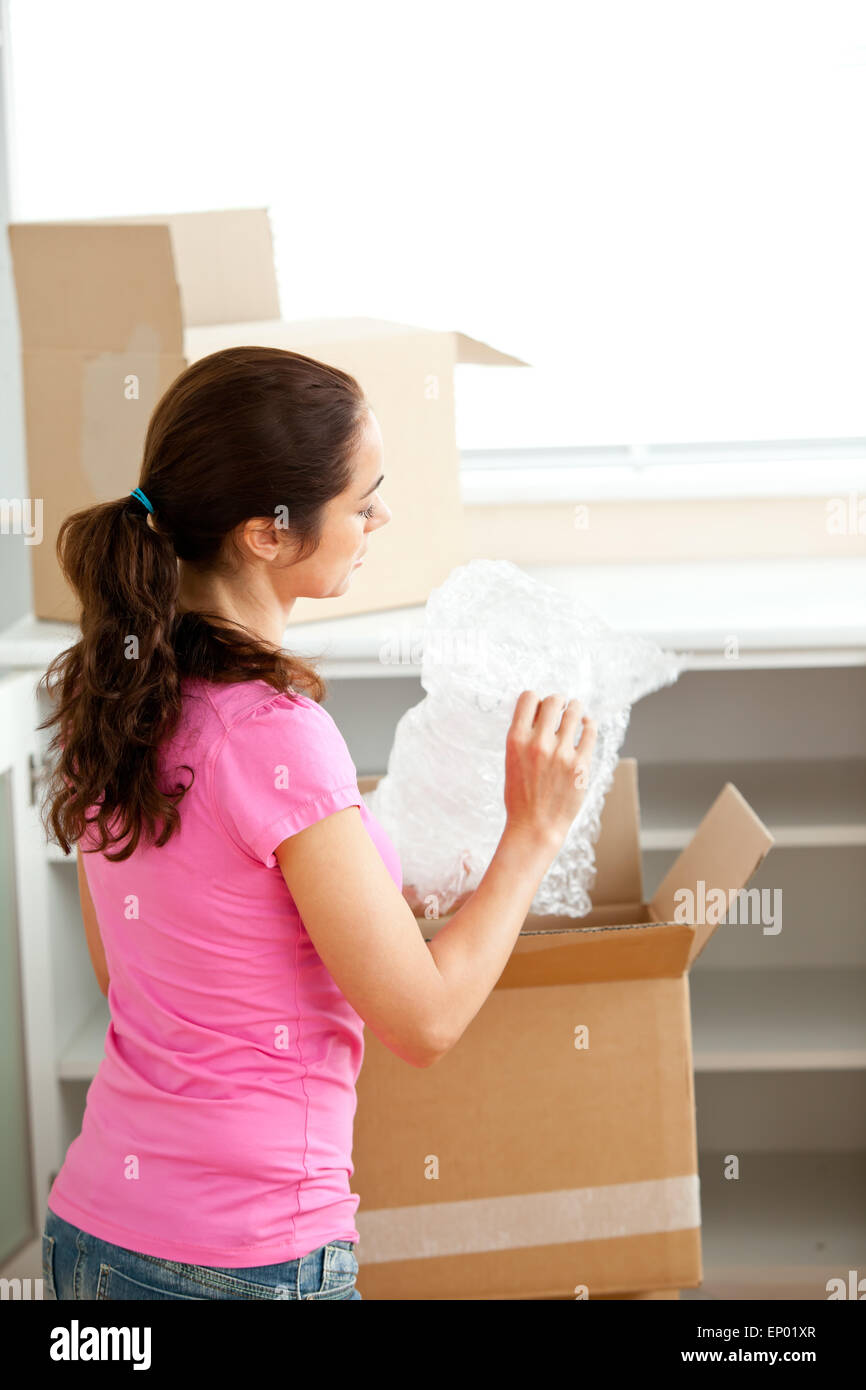 Attractive hispanic woman unpacking a box of glasses Stock Photo - Alamy