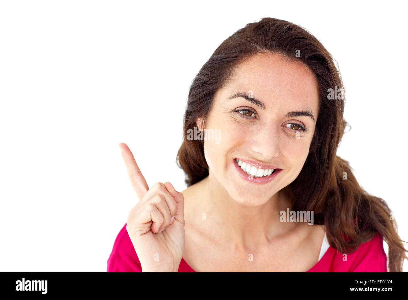 Beautiful hispanic woman pointing upward against a white background ...