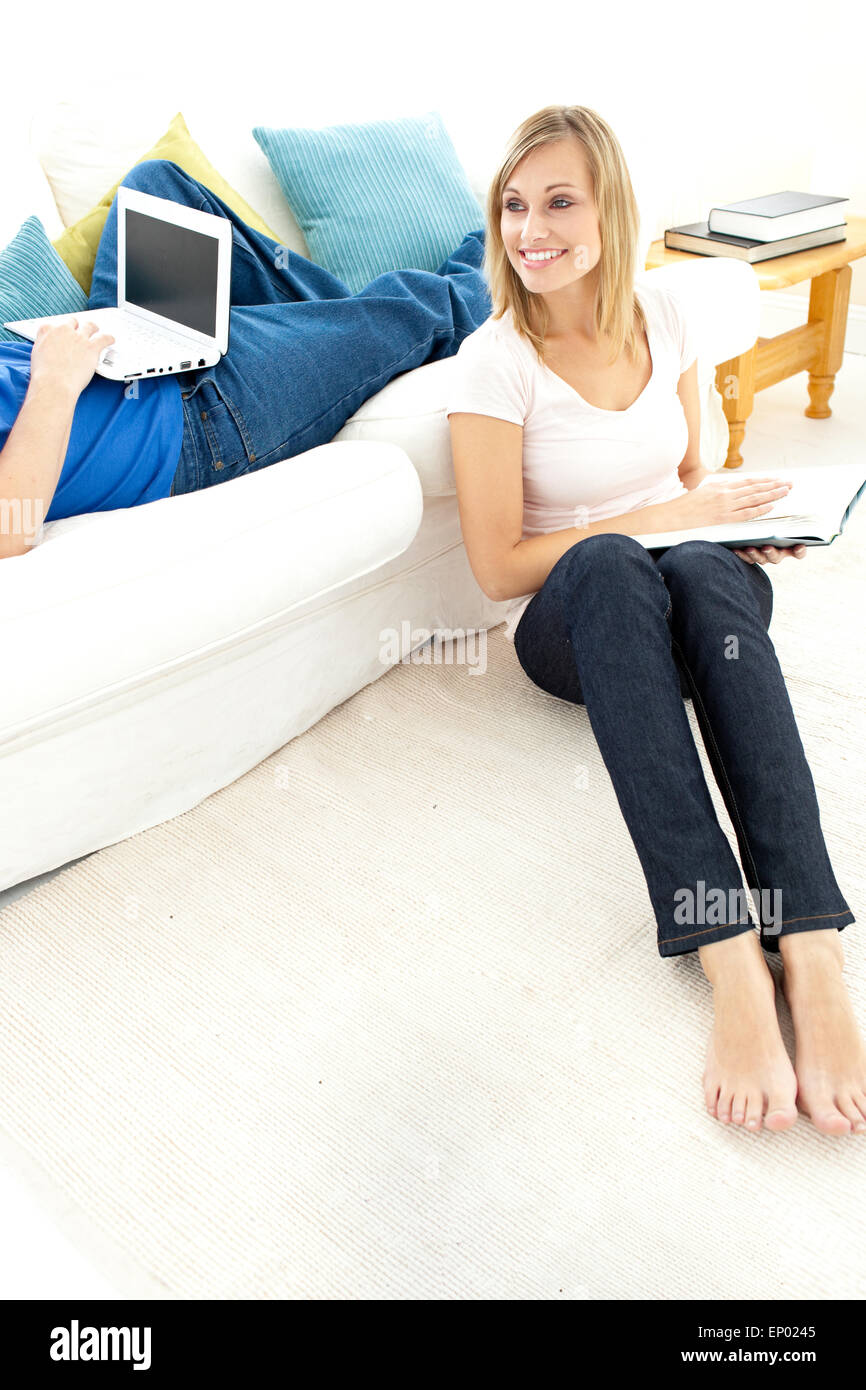 Smiling couple having free time in the living-room Stock Photo - Alamy