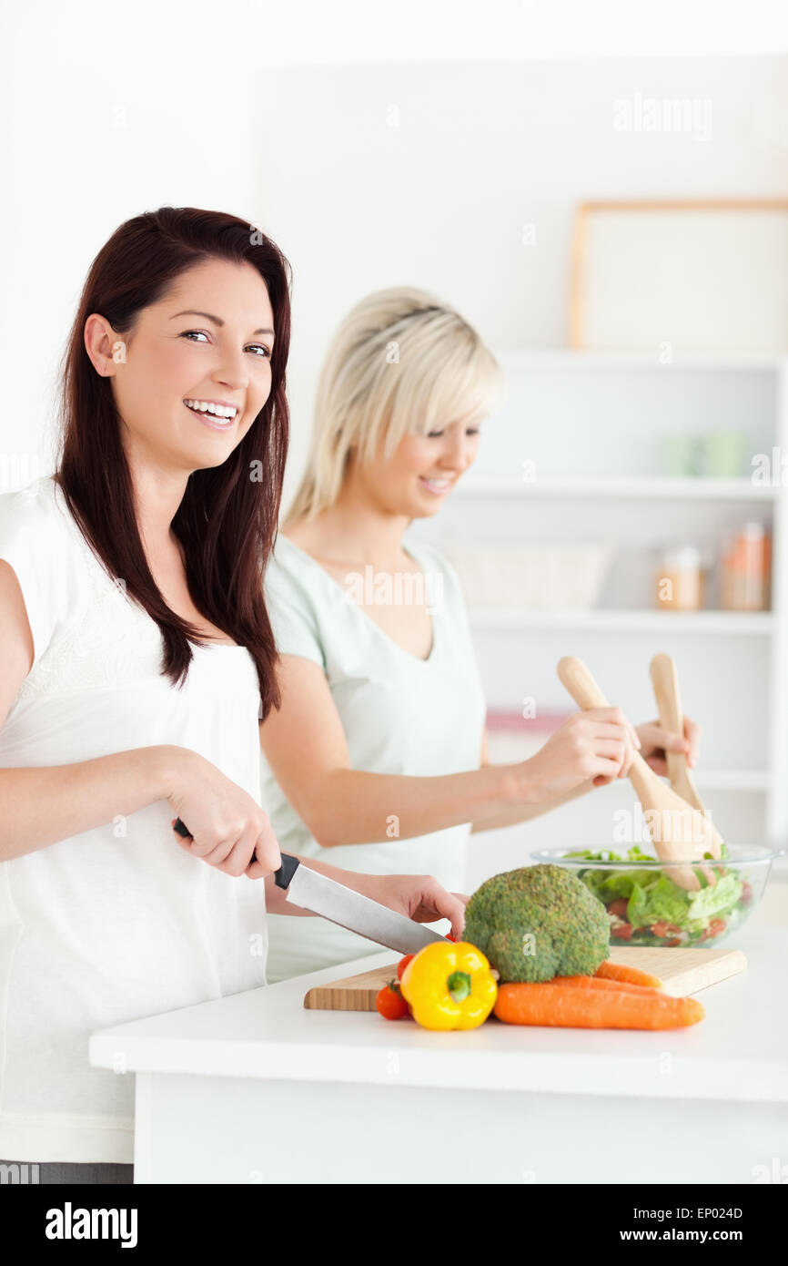 Joyful Women preparing dinner Stock Photo - Alamy