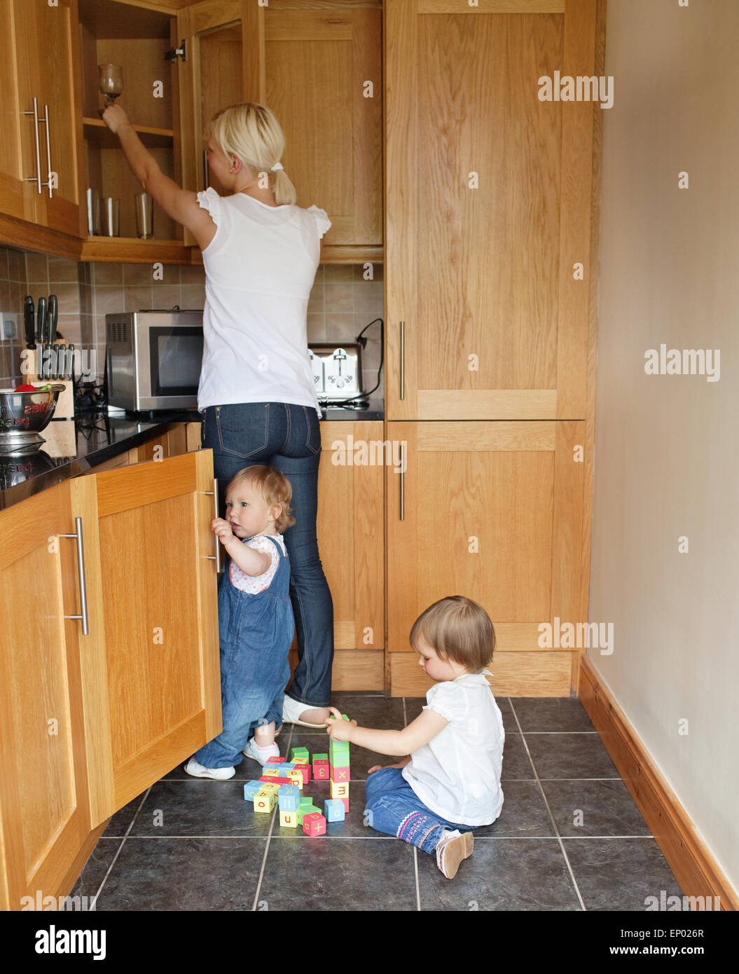 Family in the kitchen Stock Photo - Alamy