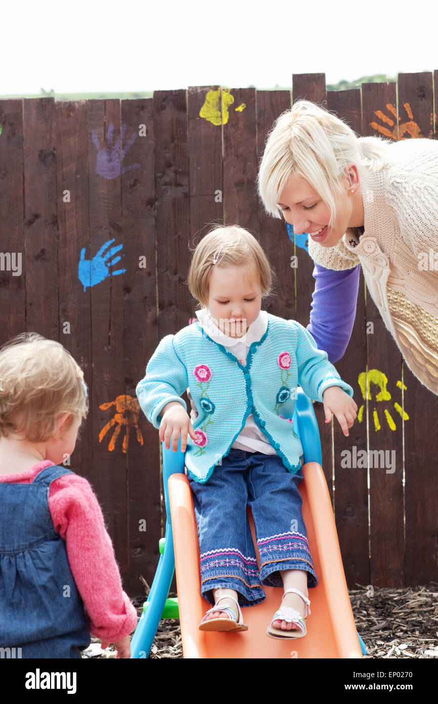 Cute girl is sliding Stock Photo - Alamy