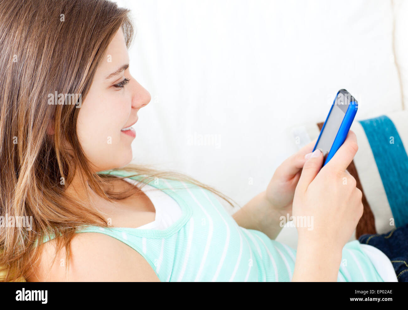 Delighted woman writing a text message Stock Photo - Alamy